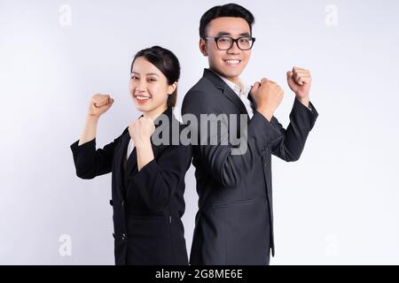 Young Vietnamese employees in suits working on the laptop on background ...