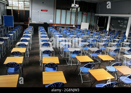 english school hall full of lines of chairs and tables for examinations ...