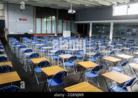 english school hall full of lines of chairs and tables for examinations ...