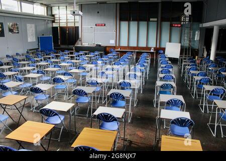 english school hall full of lines of chairs and tables for examinations ...