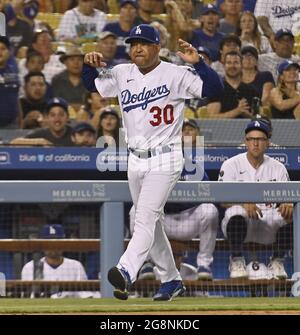 Los Angeles Dodgers manager Dave Roberts, right, plays with a young fan ...
