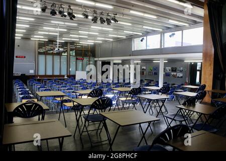 english school hall full of lines of chairs and tables for examinations ...
