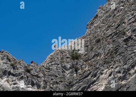 Climbers climb steep cliffs up the mountain Stock Photo - Alamy