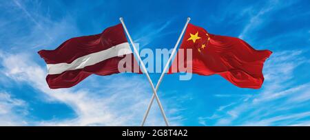 Latvia and China flag waving in the wind against white cloudy blue sky ...