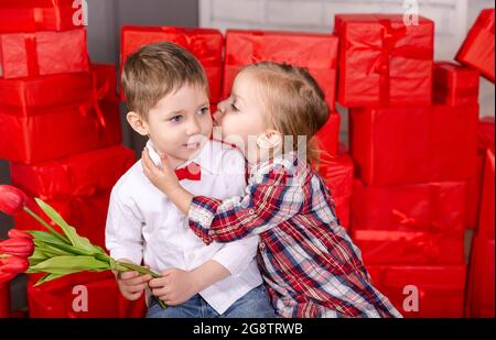 Cute couple of kids kissing each other Stock Photo - Alamy