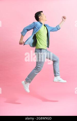 excited asian man with outstretched hands screaming while riding in ...