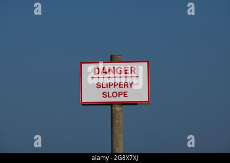 Danger Slippery Slope warning sign on Quayside Stock Photo - Alamy