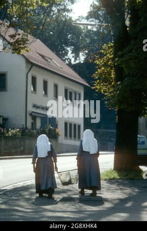 Two nuns carrying a basket of washing in 1981, Riedenburg, Bavaria ...