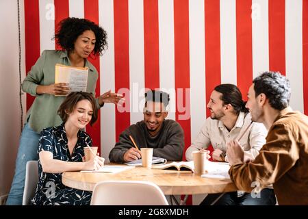 Mixed-race group shares ideas creative thoughts with multi-ethnic mates ...