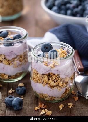 Granola parfait with bluueberry yogurt and fresh blueberries on a ...
