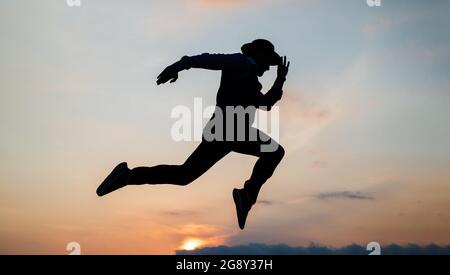 silhouette of man running in sense of freedom on sunrise sky, stamina ...