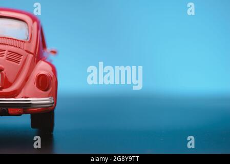 Close up shot of a Partial Backside of a red colored toy model car on a ...