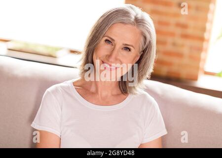 Photo of pretty adorable lady pensioner wear striped pullover walking ...