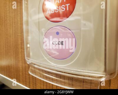 Angled close-up of a the 'Code' pink and 'Staff Assist' buttons on a ...