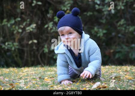 Shallow focus of an adorable Australian baby crawling on a mat on the ...