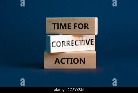 Corrective action symbol. Wooden blocks with words 'Corrective action ...