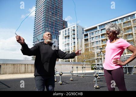 Man standing with the skipping rope in hands Stock Photo - Alamy