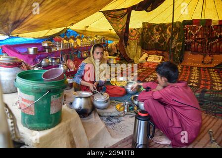 Bandipora, India. 24th July, 2021. Nomad Baqarwal people seen posing for a photograph outside ...