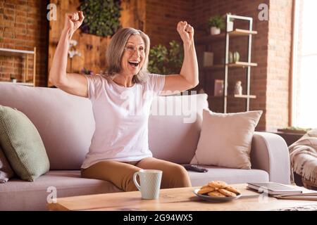 Photo of excited lucky lady wear striped white t-shirt winning ...