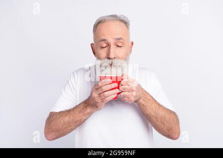 Photo of old grandfather hold mug look side empty space wear eyeglasses ...