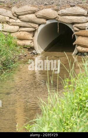 Concrete pipe watercourse culvert in a farmland area. For water ...
