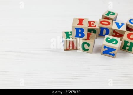 Wooden blocks spell out ABC on wooden table. Games and tools for kids ...