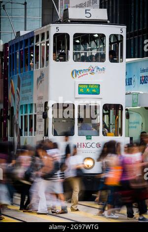 Pedestrians cross Des Voeux Road, Central, Hong Kong Island, in front ...