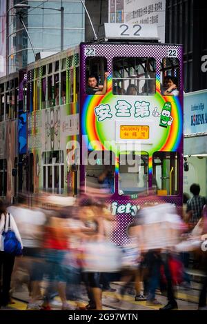 Pedestrians cross Des Voeux Road, Central, Hong Kong Island, in front ...