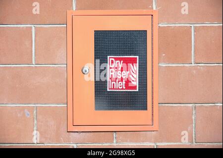 Dry riser red inlet box and sign at wall Stock Photo - Alamy