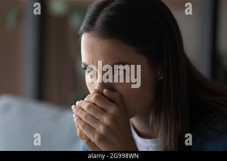 Close-up worried anxious young woman standing outdoors shouting loudly ...