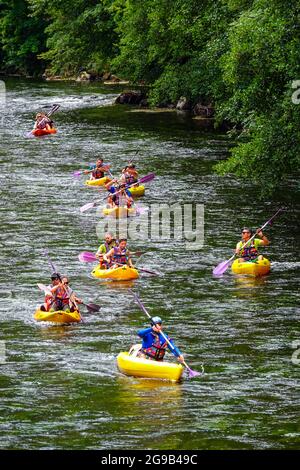 Canoeists canoeing down the Ariege River in the French Pyrenees, South ...