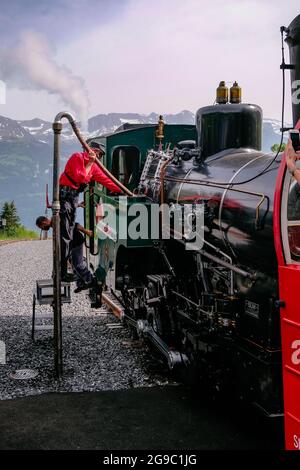 A steam engine refilling water in station Stock Photo - Alamy