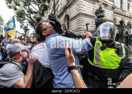 A police officer restrains a protester during the demonstration ...