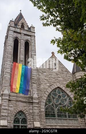 An LGBTQ+ rainbow flag hangs from a building facade in central Brussels ...