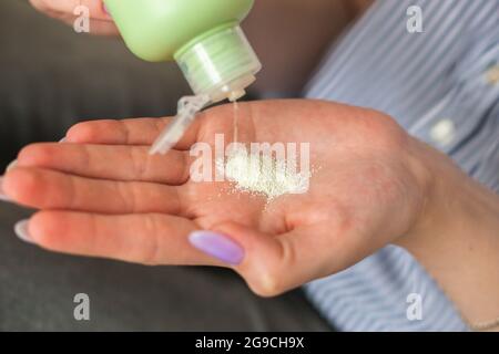 Woman's Hand Using Talcum Powder for Her Skin Stock Photo - Alamy