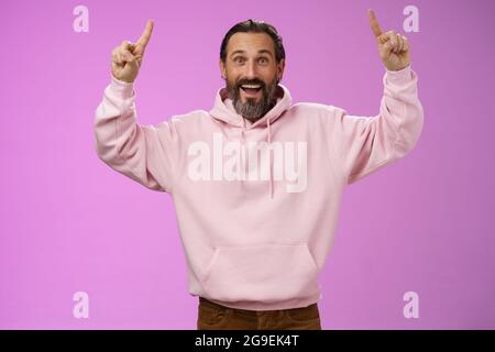 Lucky carefree stylish mature man beard grey hair raising hands ...