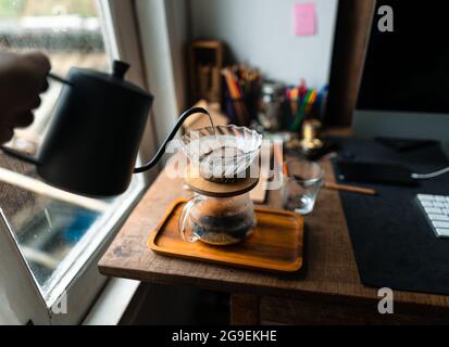 hot water into coffee dripper above glass jar Stock Photo - Alamy
