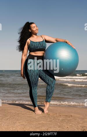Woman Holding Pilates Ball Stock Photo - Alamy