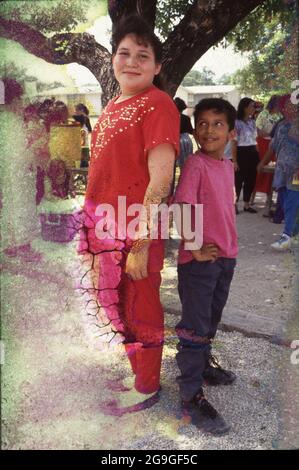 San Antonio, Texas USA, 1991: Fifth grade boy and girl compare heights ...