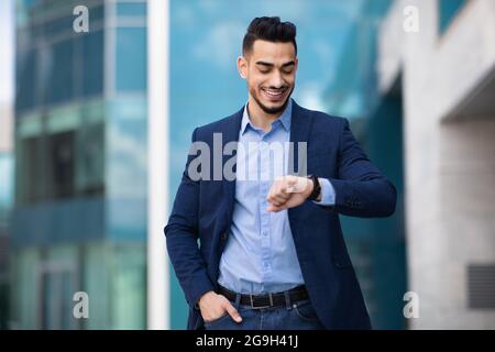 Cheerful middle eastern guy CEO working at office, using pad Stock ...