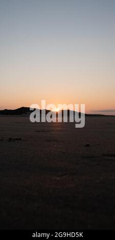 The setting sun reflecting onto the sea Stock Photo - Alamy