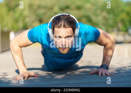 Handsome man doing pushups outdoors on autumn morning Stock Photo - Alamy