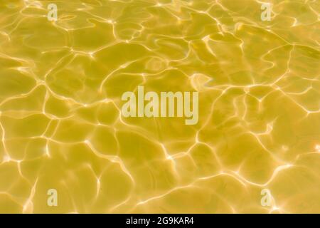 Gold swimming pool rippled water texture reflection Stock Photo - Alamy