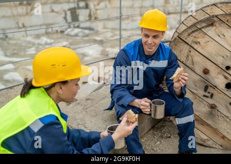 two happy builders in hardhat works on the building site Stock Photo ...