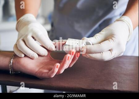 Nurse placing finger monitor on patient Stock Photo - Alamy