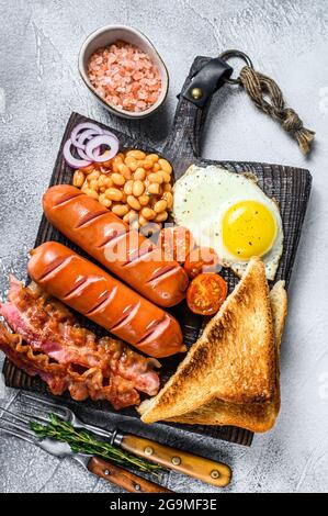 Full fry up English breakfastt with fried eggs, sausages, bacon, beans ...