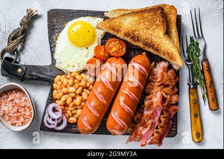 Full fry up English breakfastt with fried eggs, sausages, bacon, beans ...