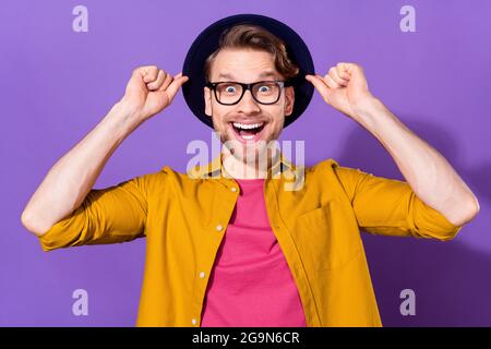 Photo of charming young amazed man hold hands red paper heart shape ...