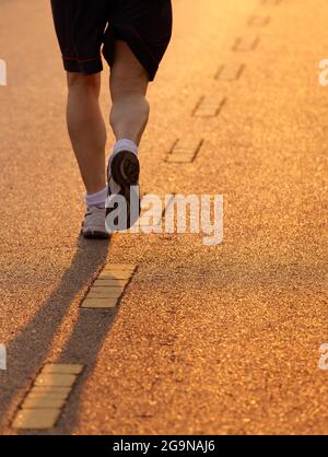 Marathon running in the light of evening Stock Photo - Alamy