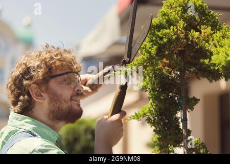 Portrait of redheaded bearded man, farmer working in the garden ...